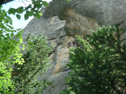 Climber on the second pitch which does a long hand traverse.