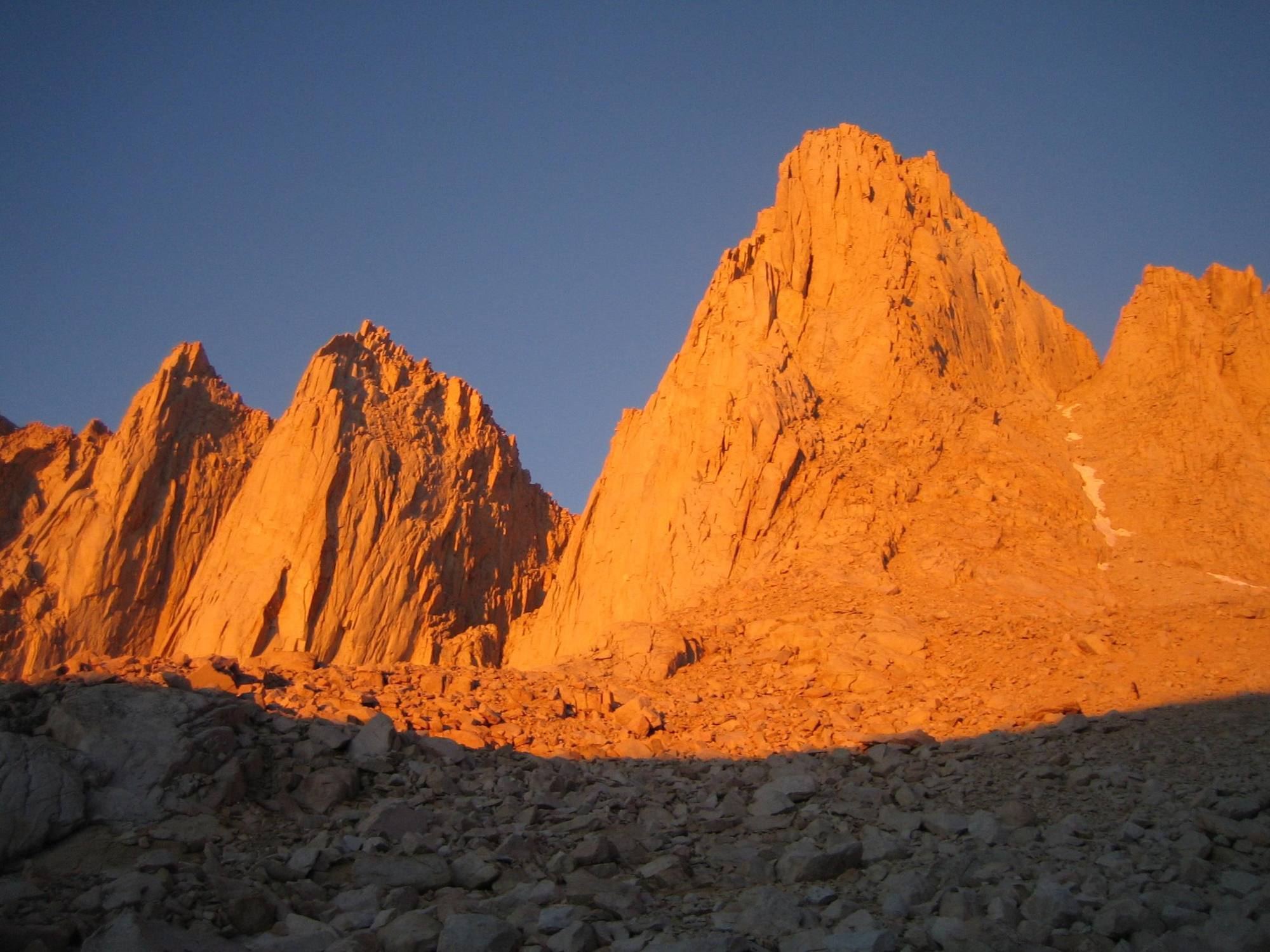 Mt. Whitney at sunrise. Mountaineer's route goes up the snowy gully ...