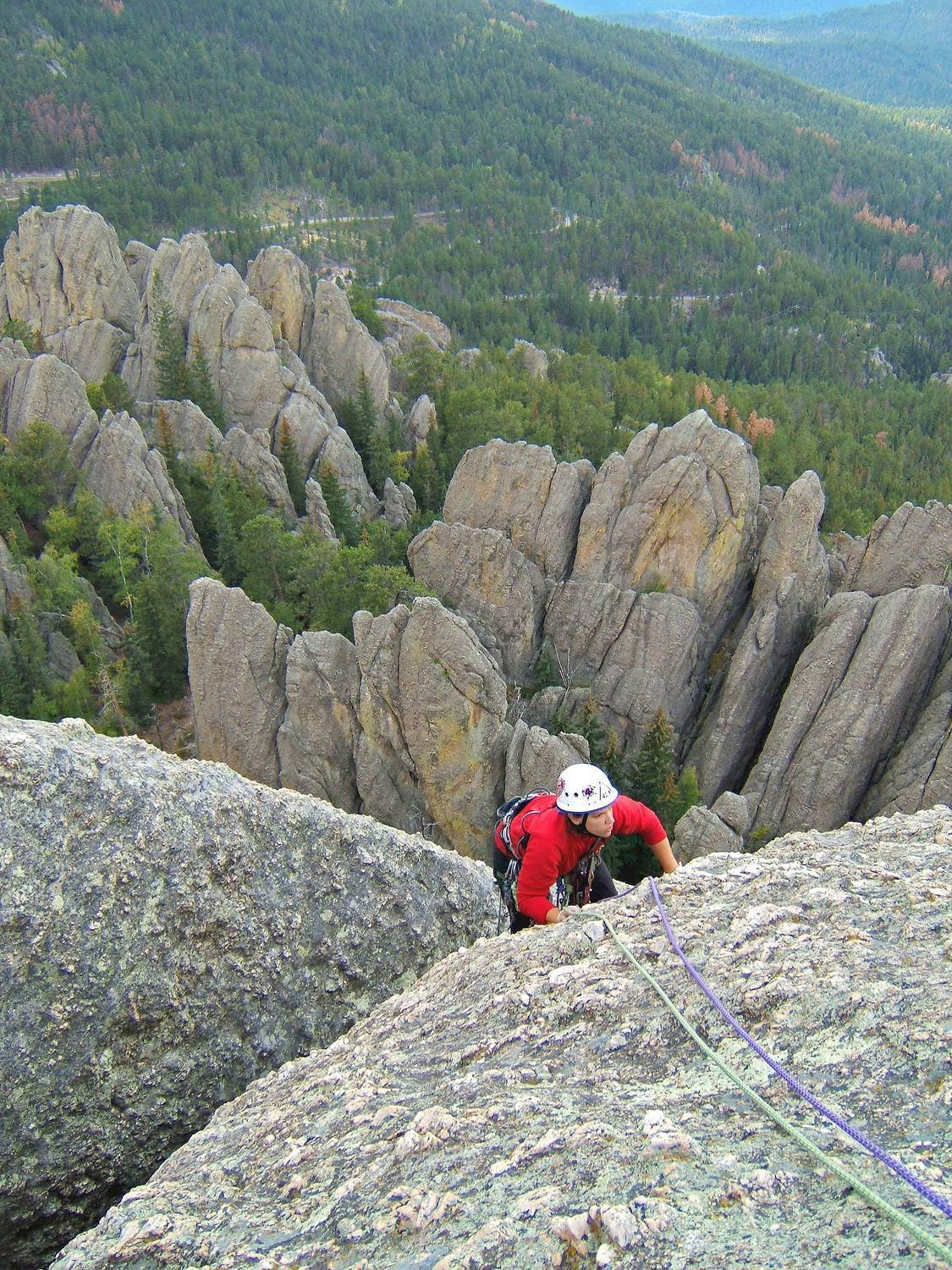 Angela Arp scrambles up the last bit of knobbly rock to reach the ...