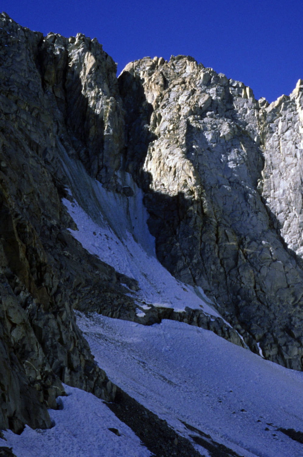 North face of Mt. Mendel. A team of climbers can be seen ascending the ...