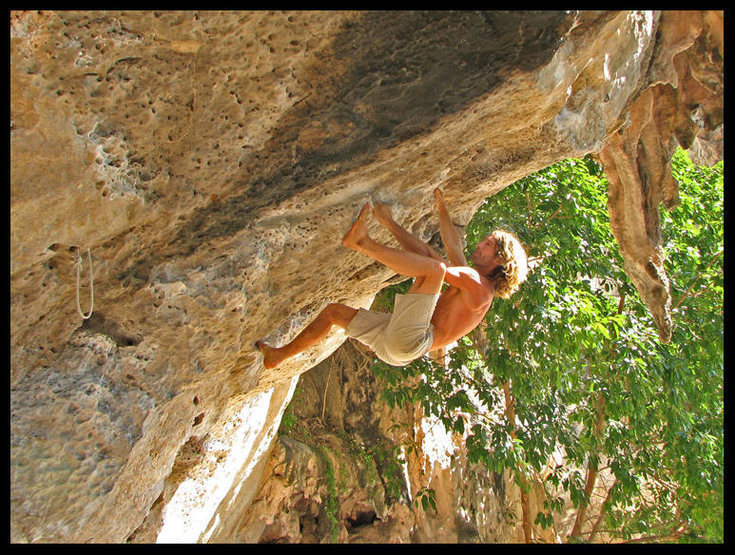 Barefoot bouldering at the popular back wall on Phra Nang Beach. Who ...