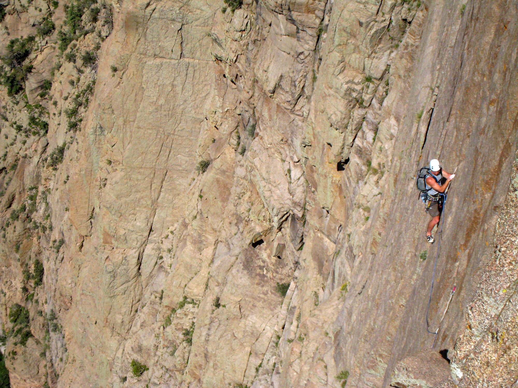 Traversing right on the slabby, unprotected face moves on pitch 4.