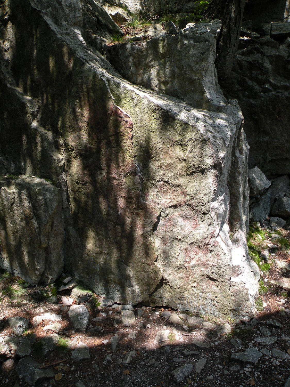 Start on the chalky holds at the center of the face of the Stained boulder.