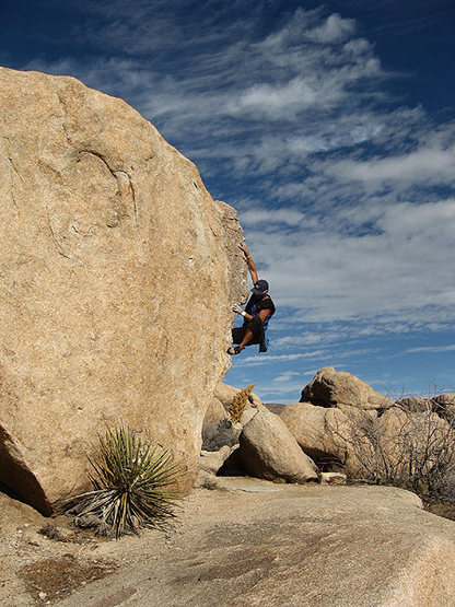 Climbing in Native Arete Boulder, Joshua Tree National Park