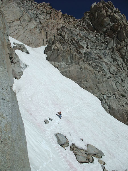Crossing the snow gully to reach the base.