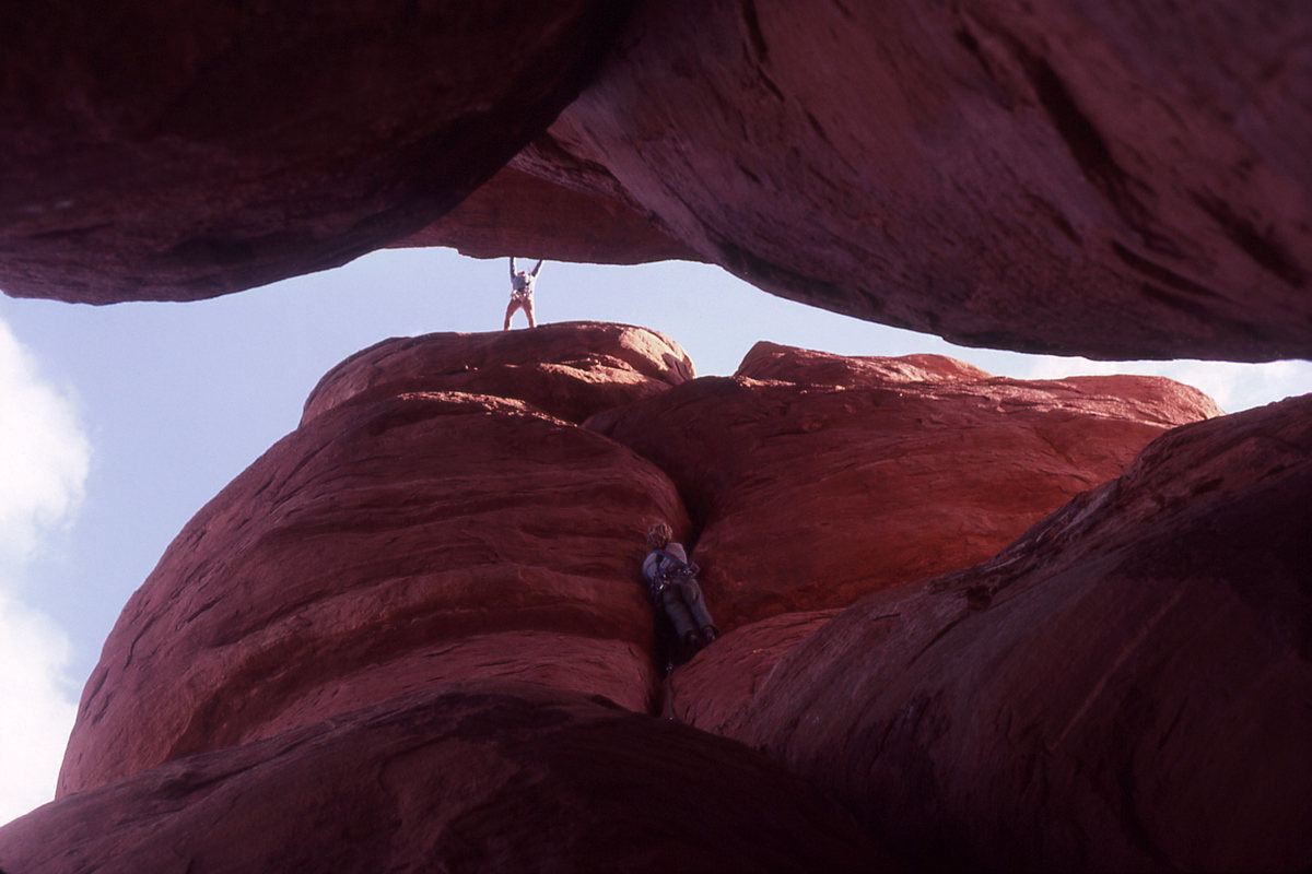 Tim Coats on the second pitch crux, while another climber on the ...