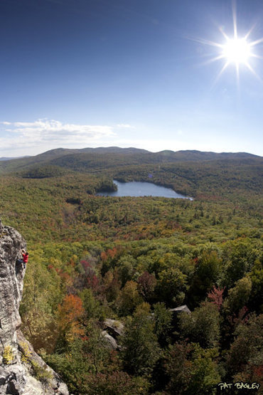 Bill Morse on The Ritual (5.13a) with Shagg Pond in the distance. Photo ...