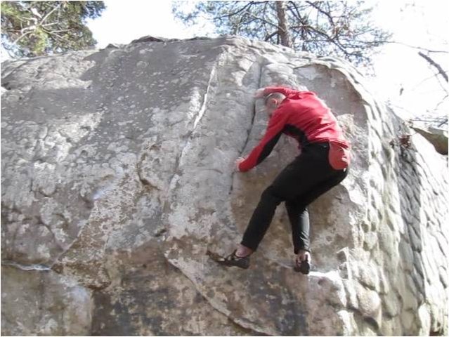 In the layback crack, prepping for the slabby topout.