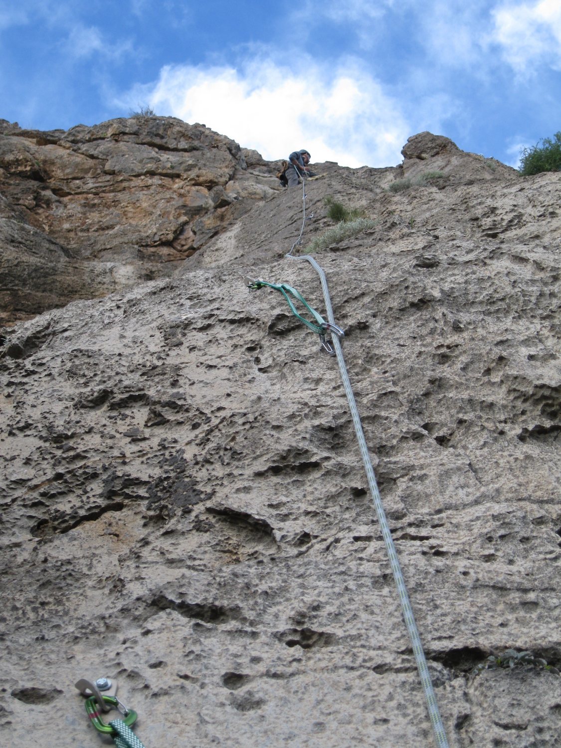 Jon pulling up the rope to rappel down Redolence. There are lots of ...