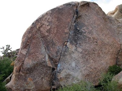 Climbing in Classic Thin Crack Boulder, Joshua Tree National Park