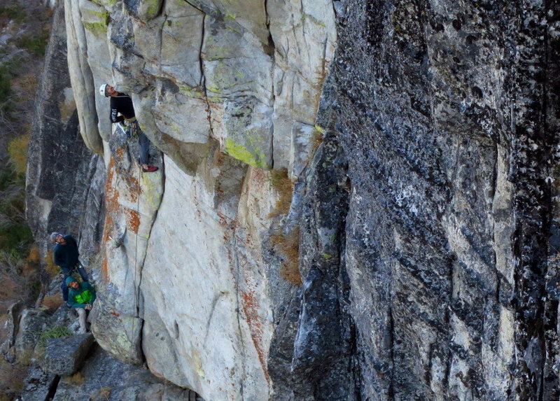 A climber contemplates the steep hand-traverse on Eagle Buttress Right ...