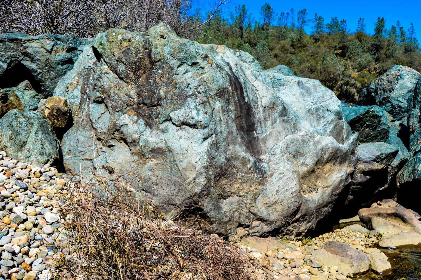 4 or more lines on this bright green limestone boulder set right by the ...