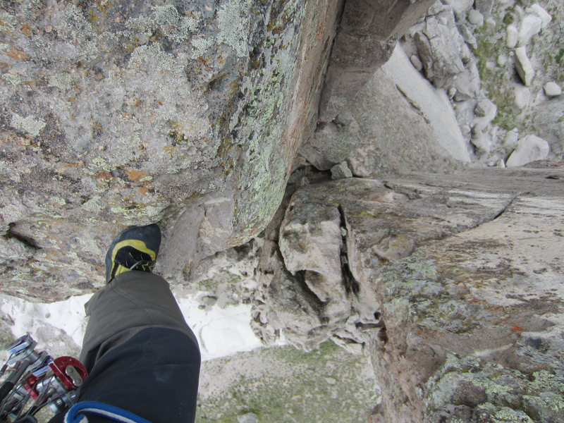 Stepping across the exposed gap to the eastern summit.