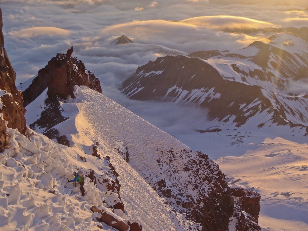 Joe traversing sun cupped snow slopes to pass the prominent gendarme on ...