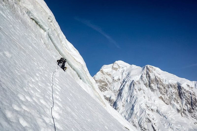 Death traverse under false summit cornice.