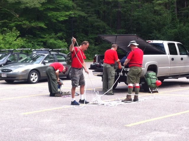Scout leaders demonstrating proper rope management in the CCC parking lot.