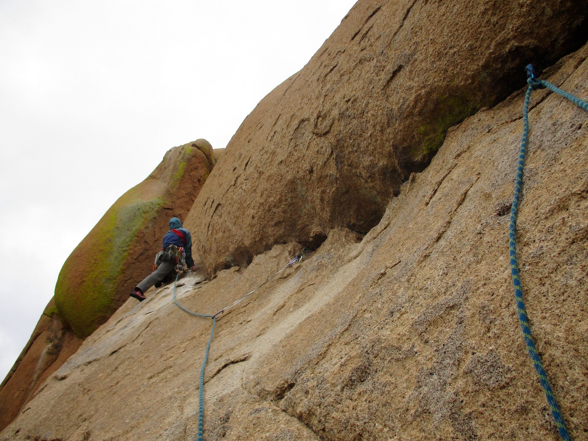 Julie beginning the traverse on Pitch 3. There is one bolt to protect ...