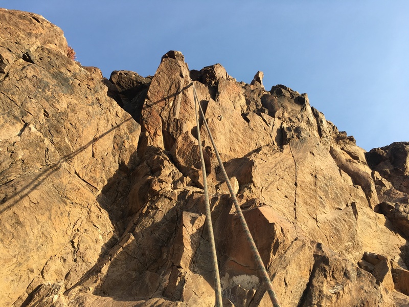 Top rope on Loose Lieback. Note the white painted hangers above. The ...