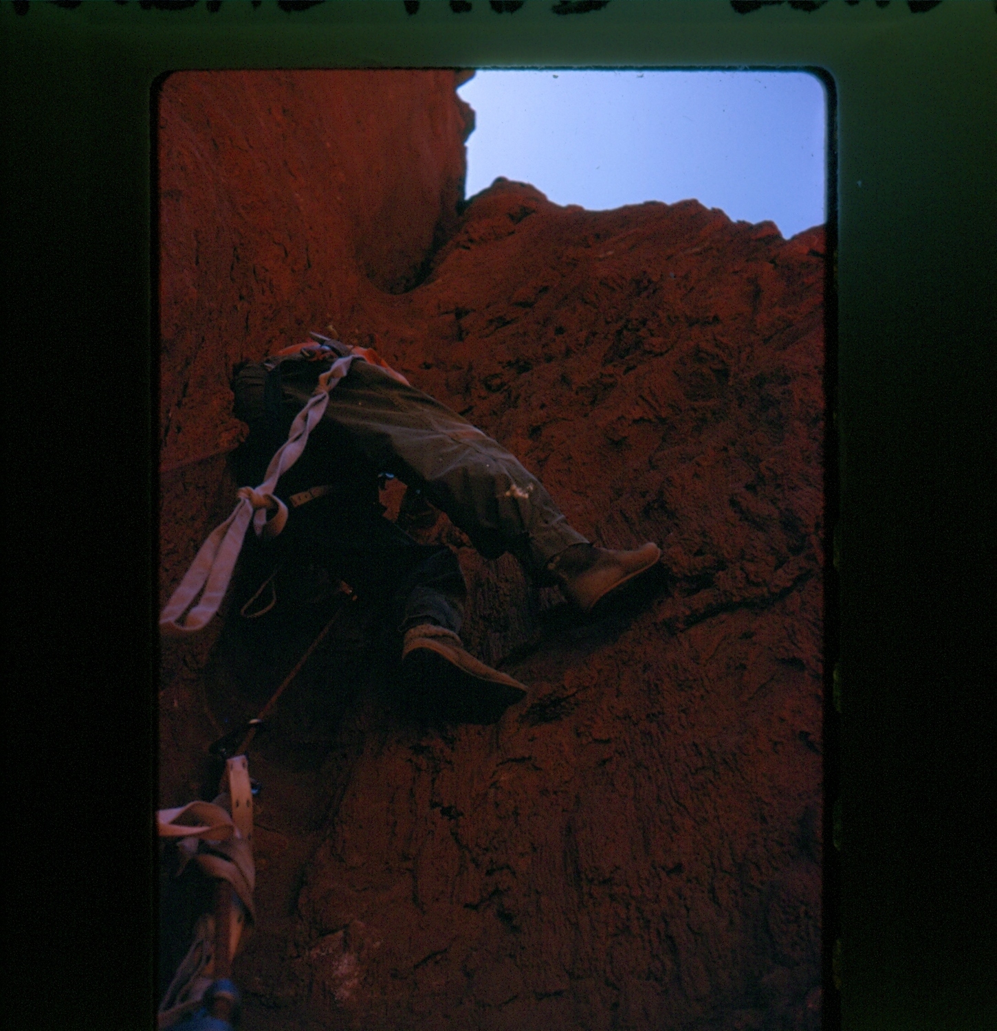 George Hurley climbing vertical mud on the first ascent