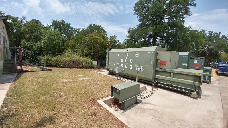 Gate down to climbing area behind trash compactor.