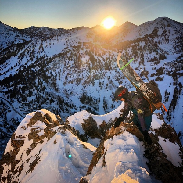 Filmer Croshane Hillyard climbing with a powder surfer split board ...
