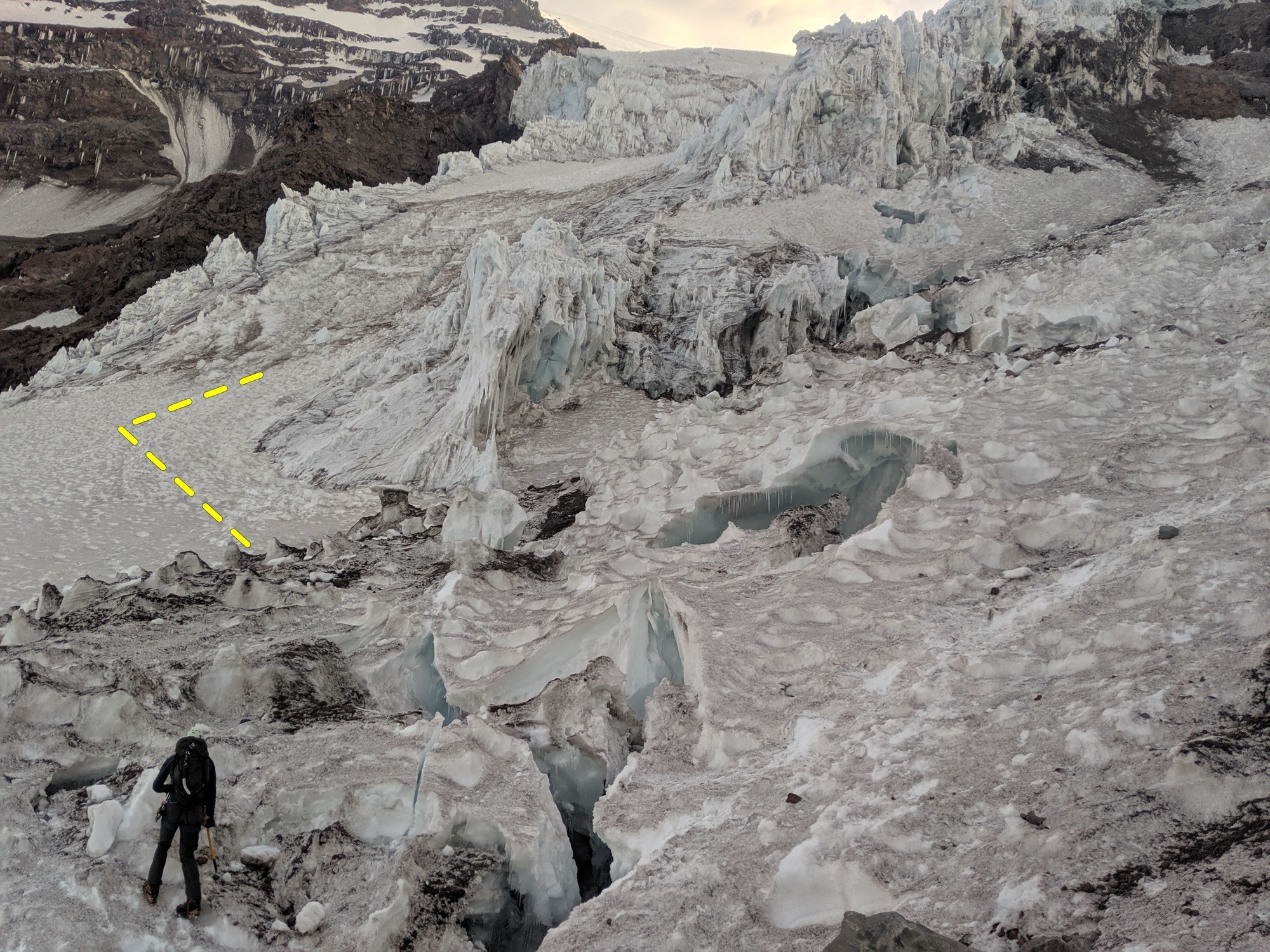 Traverse under seracs following rock step, lower Kautz ice chute seen ...