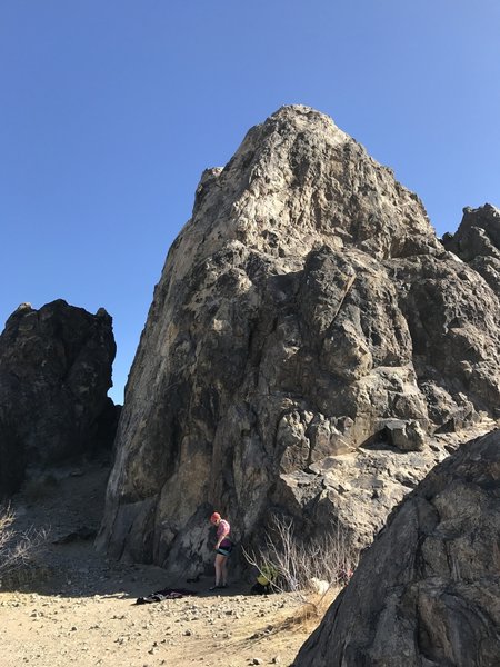 She is standing at the base of the route, and the arete is directly ...