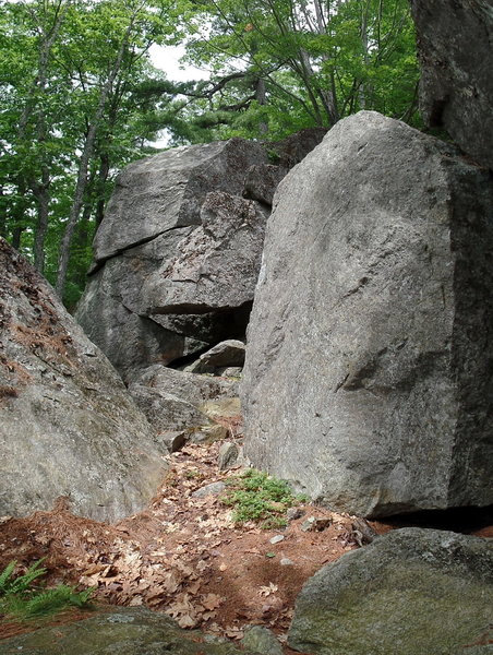 Climbing in Tombstone boulder, -Camden Hills