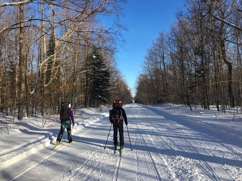 Skis make the approach quicker. Plus you get some good downhills.