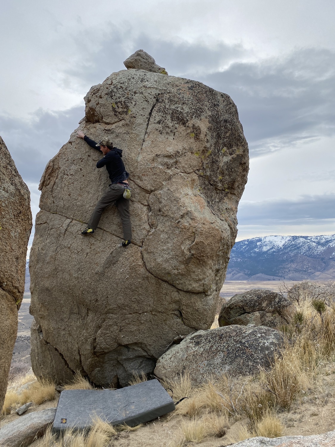 Making the awkward reach across to a marginal hold on shaky feet.