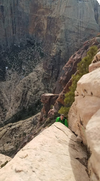 Narrow ledge on Armatron walkoff. There's a 30 foot drop to the left ...