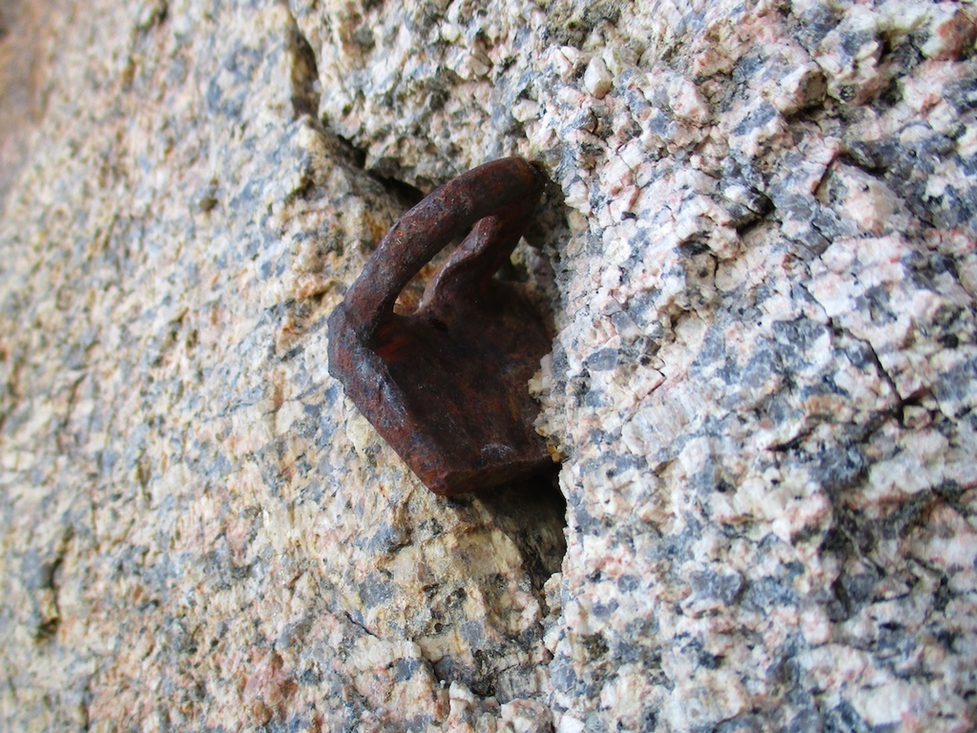 An old piton. The kitty litter rock quality is representative of much ...