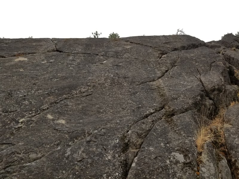 Indian Burn ascends the slabby face, croses a thin seam, and passes two ...