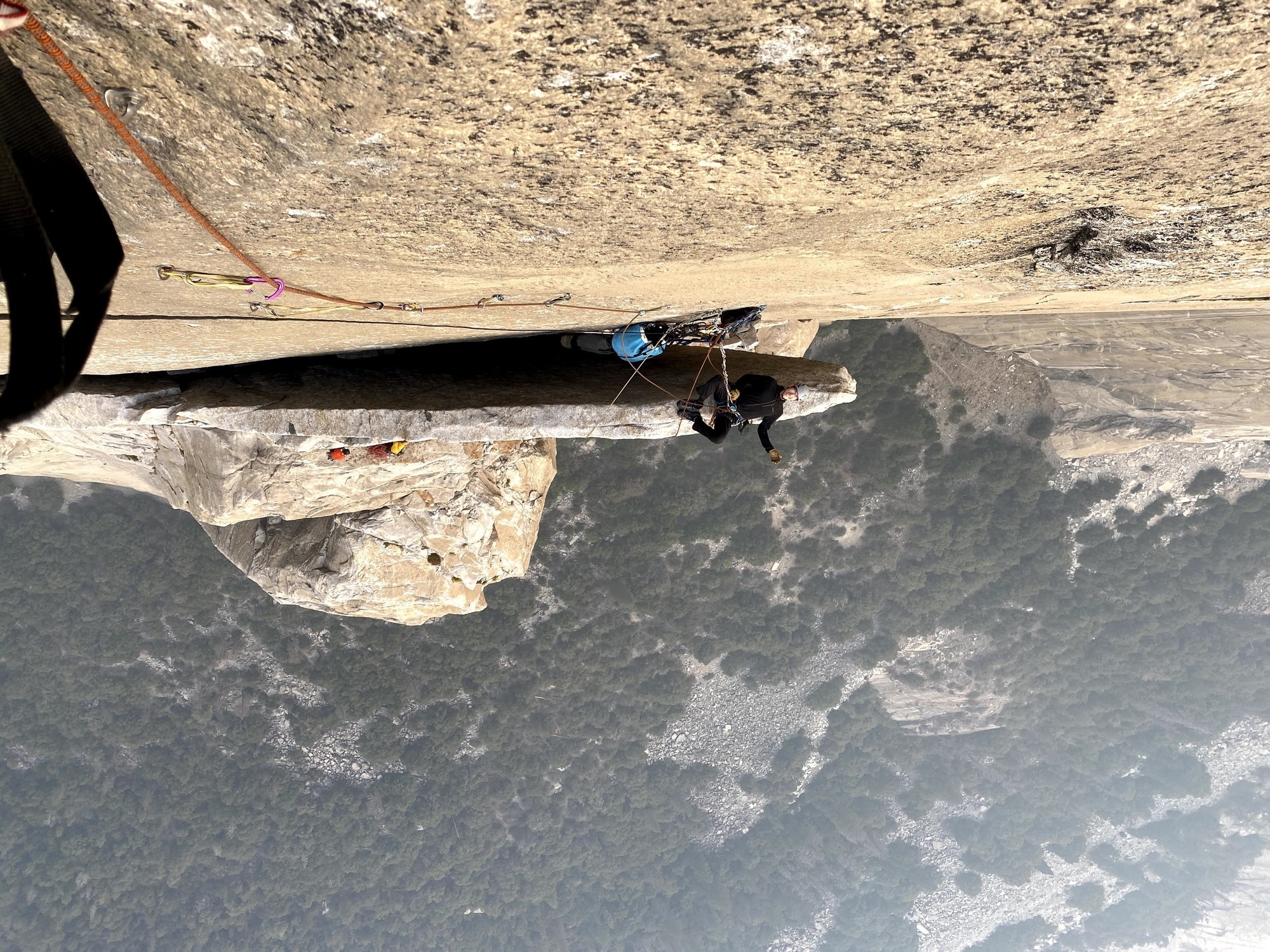 Aaron demonstrating correct form, belaying from the Texas Flake
