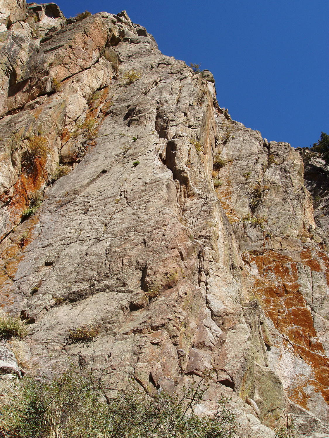 The first pitch follows corners and cracks left of the blunt buttress ...
