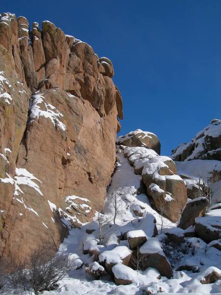 The route climbs the wall below the overhang on the right of the ...