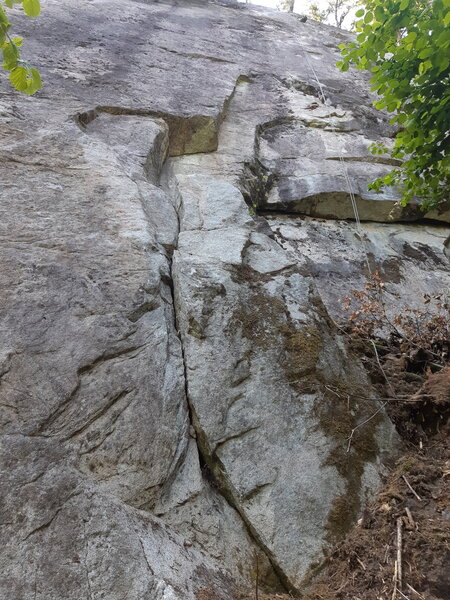 Climb the crack to the small roof and pull into the layback.