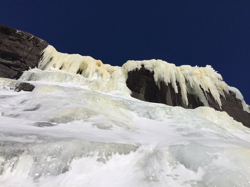 Upper crux where it flows over the headwall. Caves and parasols.