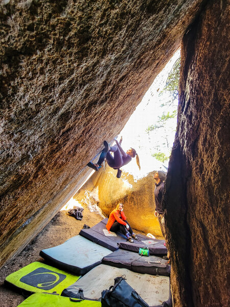 Sam climbin', showing the steepness of the boulder.