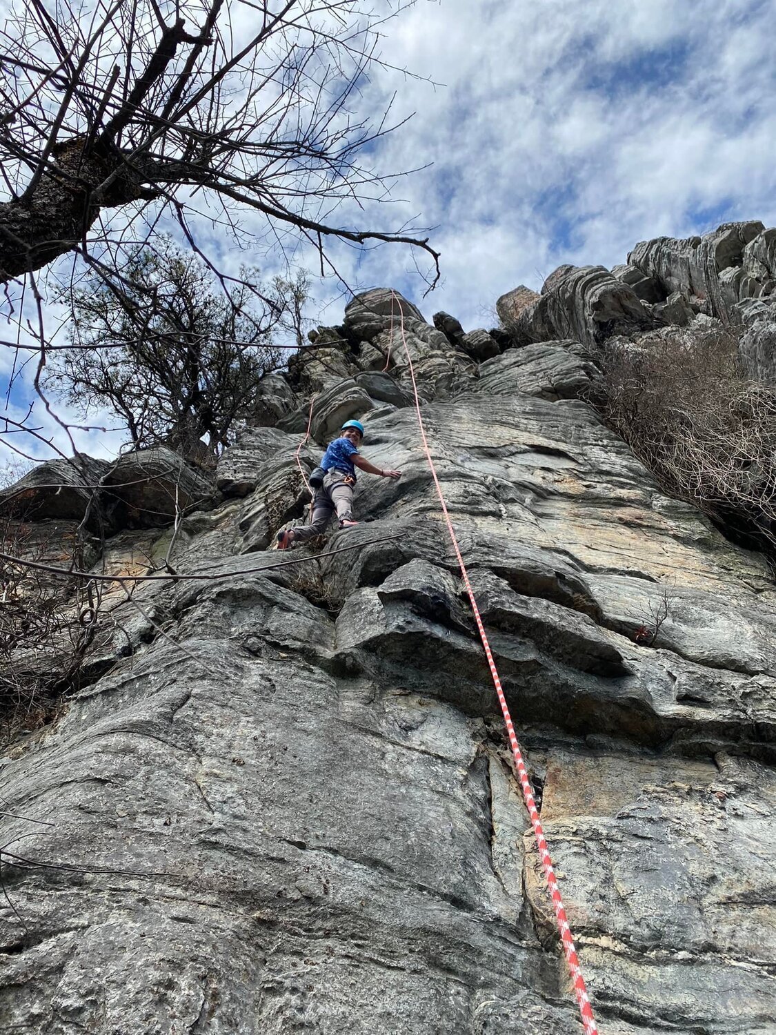 Jamie under the first pillar to the left. Very featured climbing up the ...