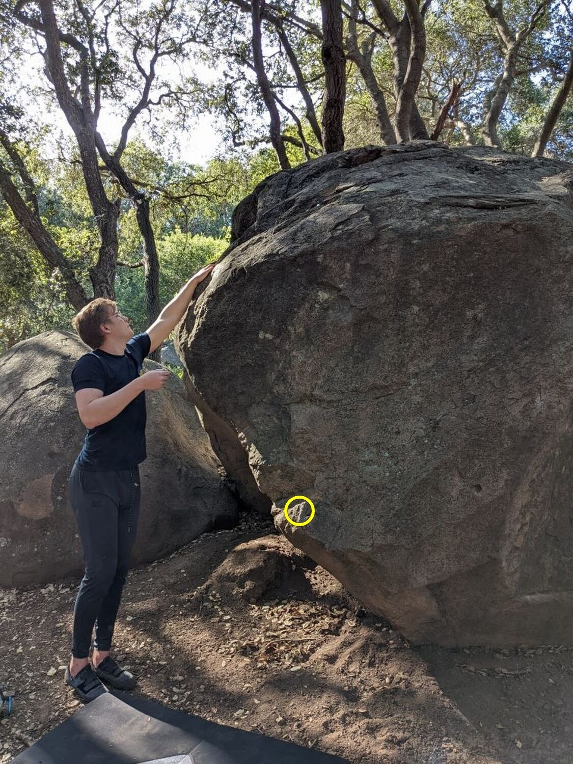 Front corner of the boulder, to the right of the trail. There's ...