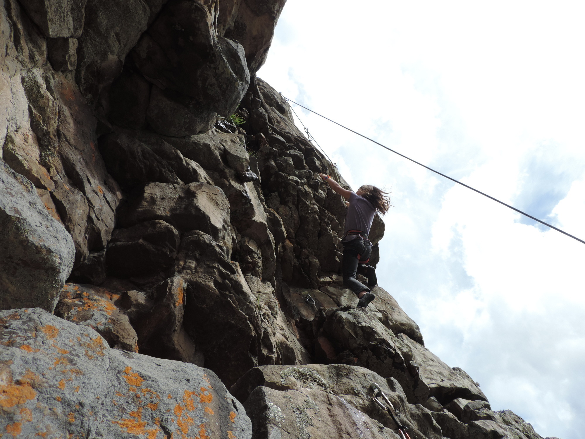 Ceci climbing the steep jugs of the 10th bolted route when she was 12