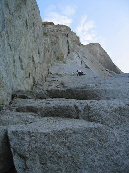 Peter Gram leading the crux traverse on the first pitch of Perhaps.