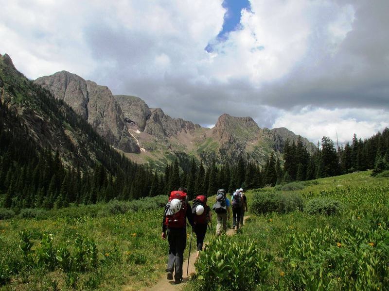 Hikers stroll into camp with Chicago Basin's Needle Mountains in the ...