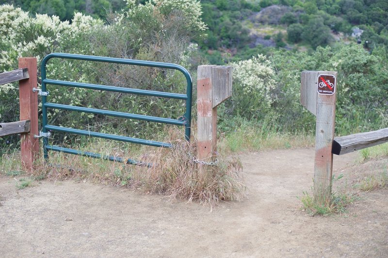 The trail passes through a gate that prevents horses and mountain ...