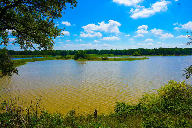 The view of an inlet of Lake Texoma from a well placed bench.